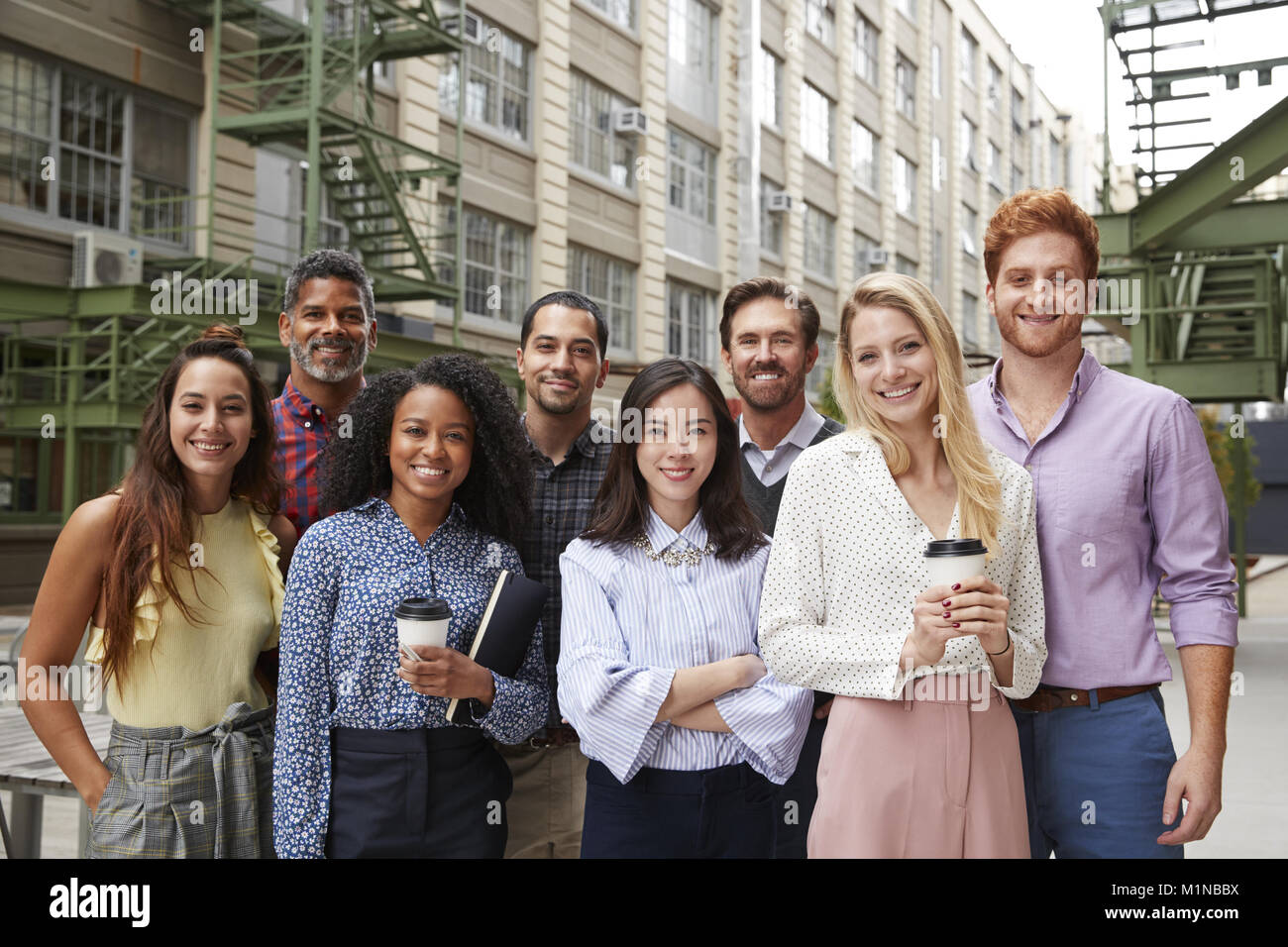 Portrait Of Eight Friendly Coworkers Outside Their Workplace Stock