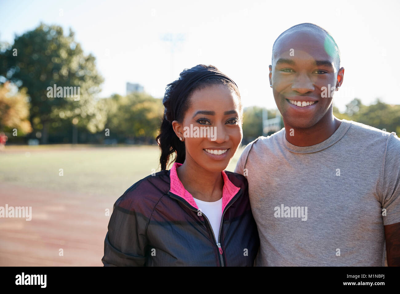 Young black couple smiling to camera in Brooklyn park Stock Photo - Alamy