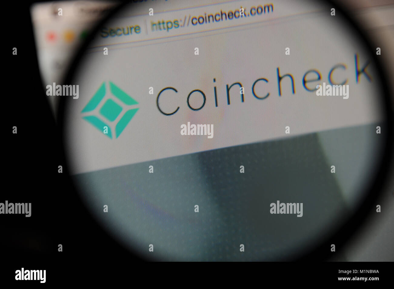The Coincheck website seen through a magnifying glass Stock Photo - Alamy