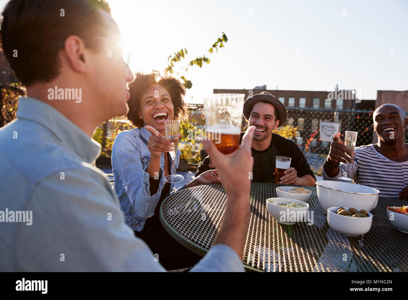 Friends having a small party on a New York rooftop, close up Stock ...
