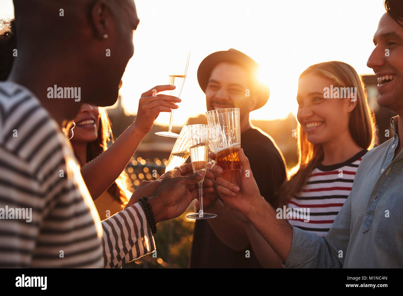 Friends making a toast at a rooftop party, close up Stock Photo - Alamy
