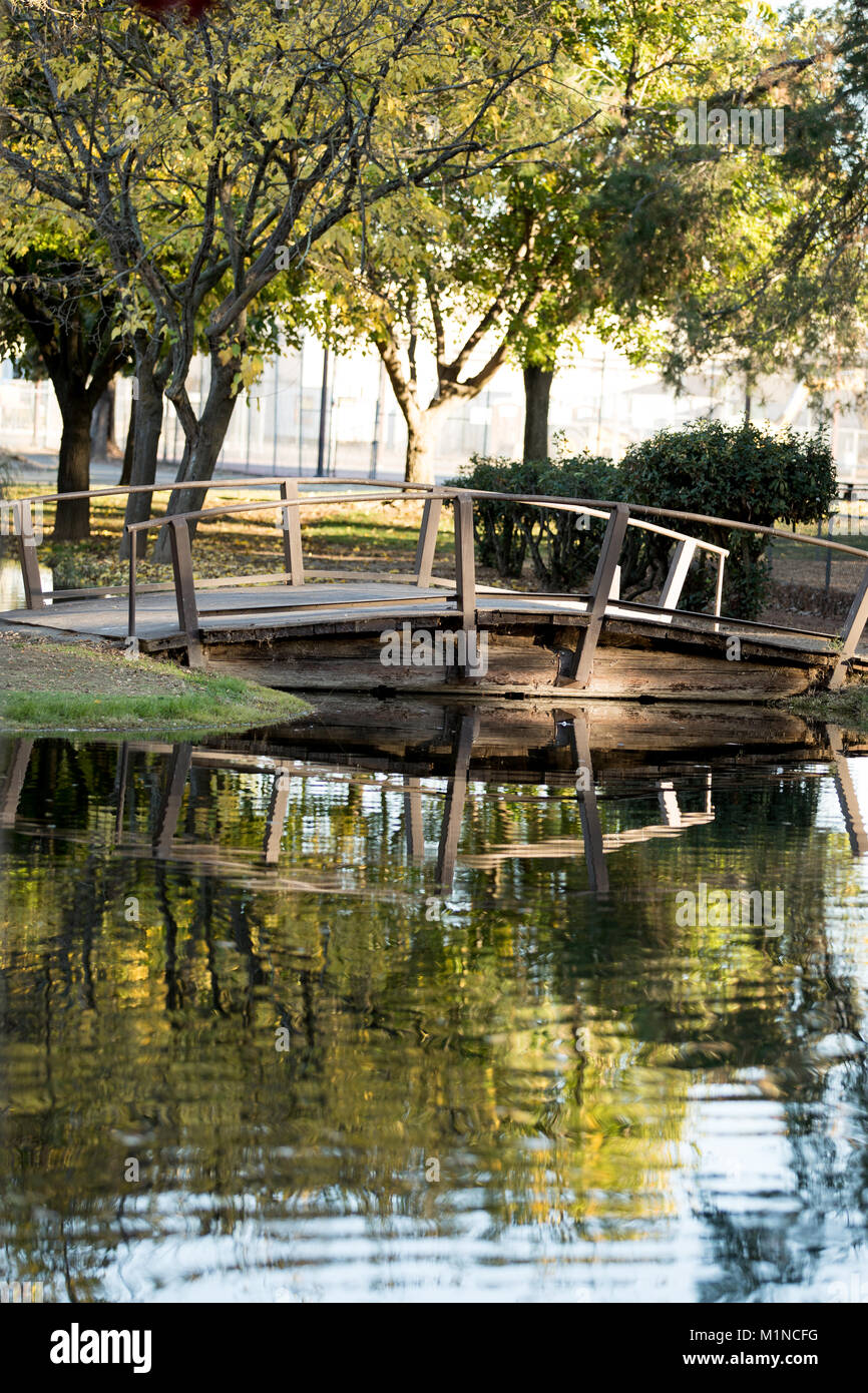 Little wooden bridge over small pond Stock Photo - Alamy