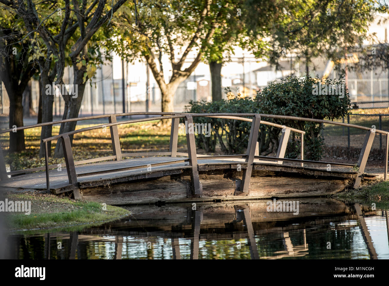 Little wooden bridge over small pond Stock Photo - Alamy