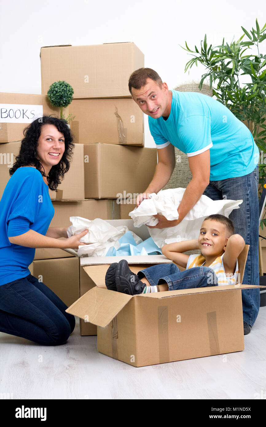 happy family unpacking boxes and moving into a new home Stock Photo - Alamy