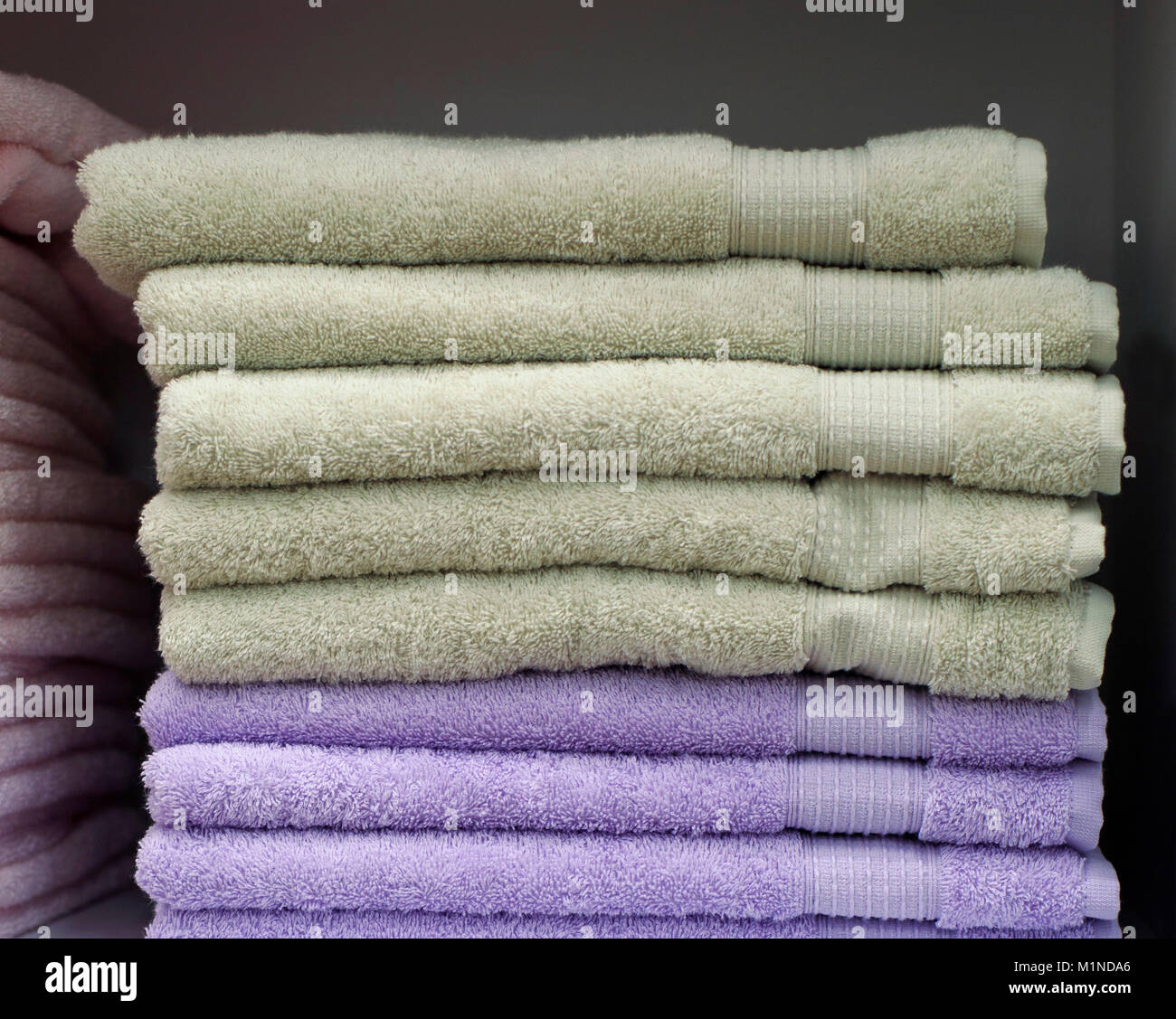 Blurred photo of Big shelf with a colorful stack towels Stock Photo - Alamy