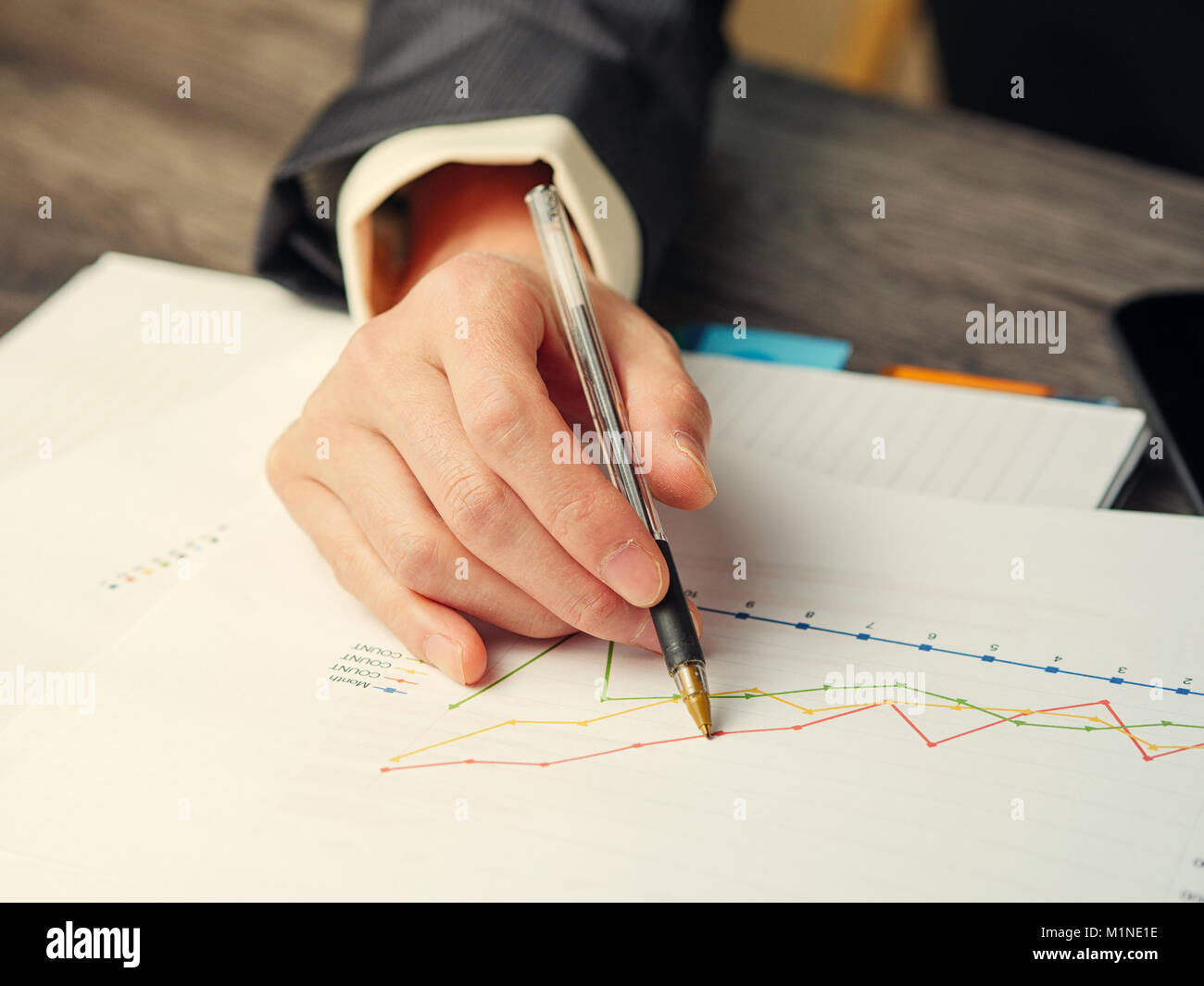 Business man checking line chart Stock Photo - Alamy