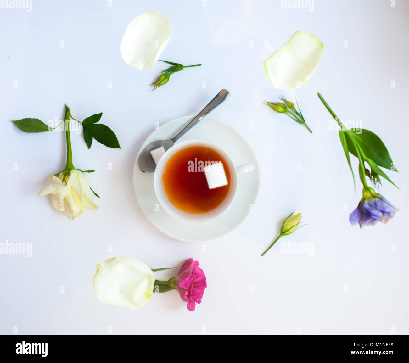 flatlay with elegant tea set surrounde by flowers Stock Photo - Alamy