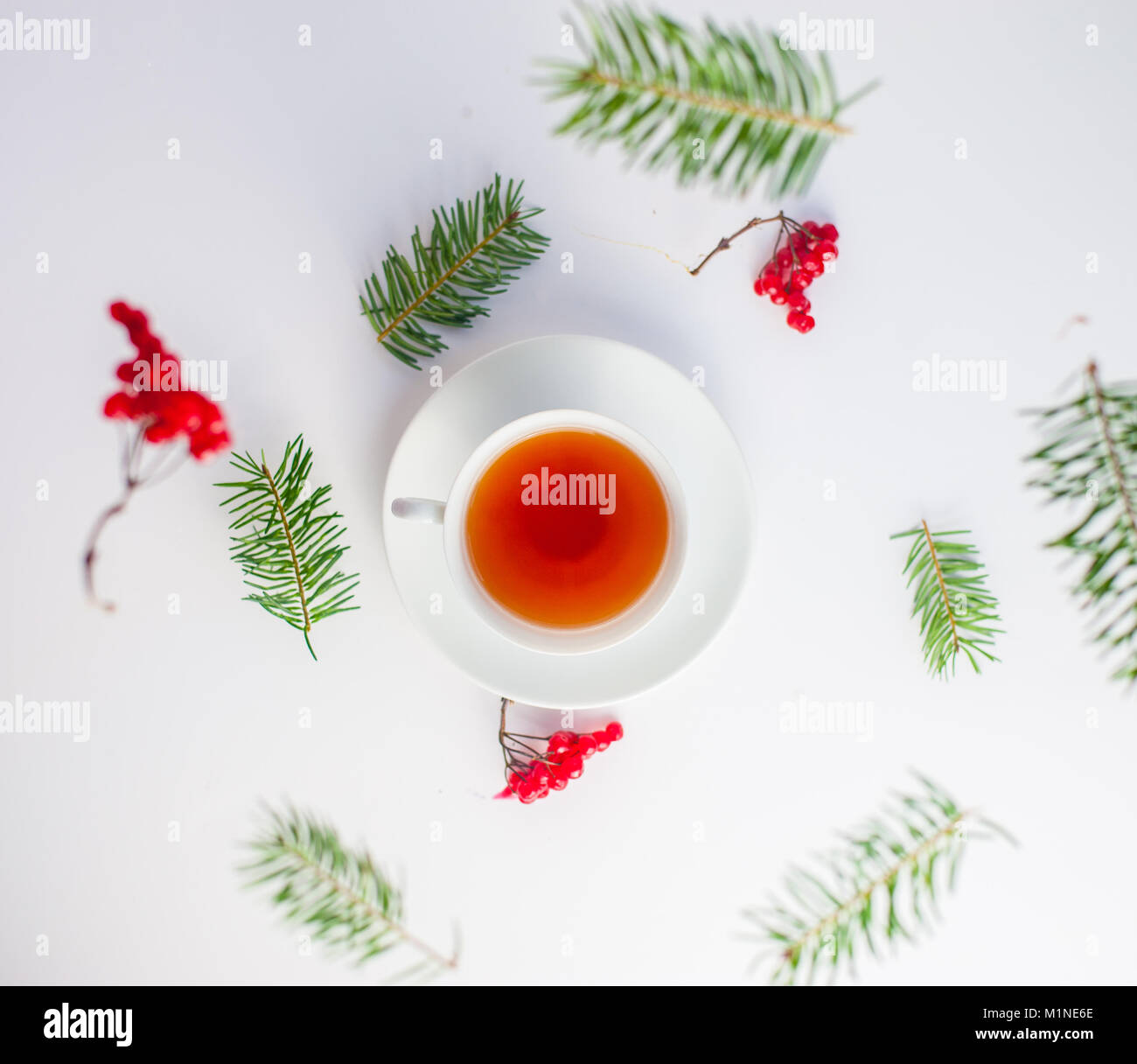 flatlay with white tea set full of tea surrounded by falling down ...