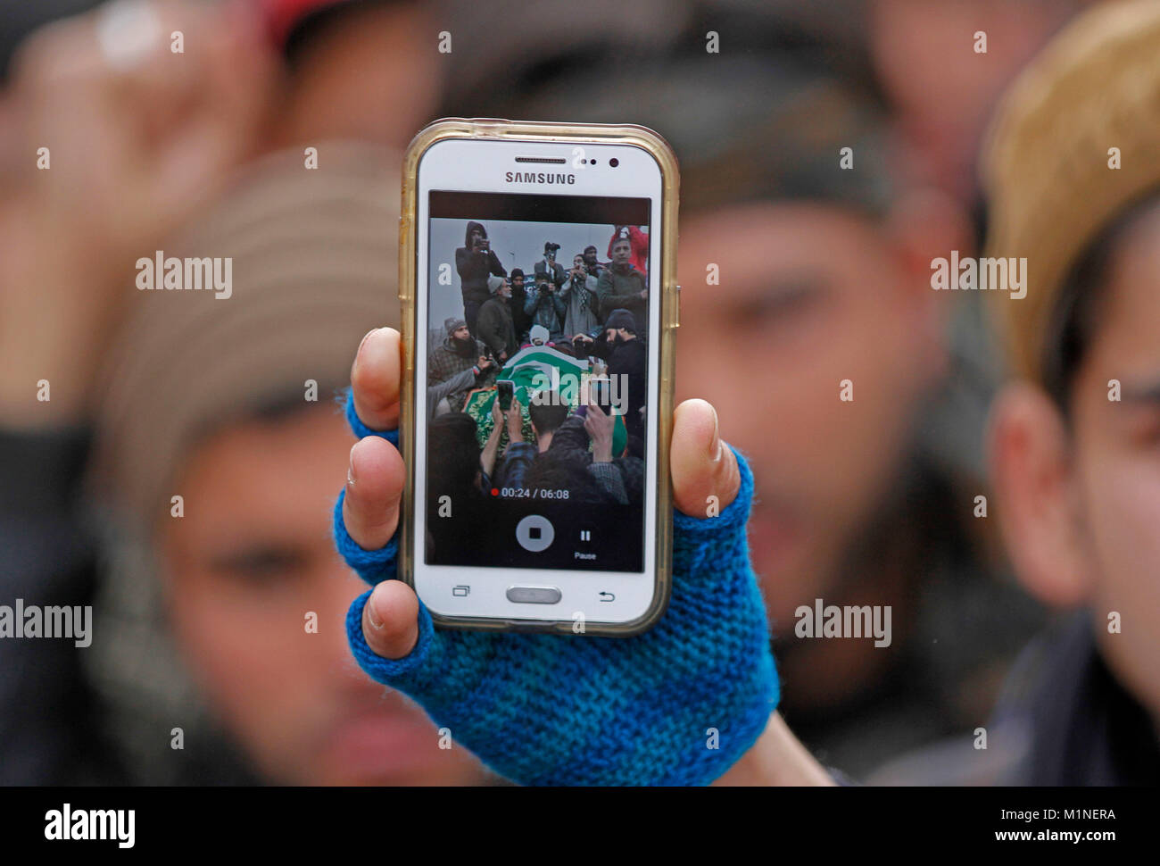 India. 30th Jan, 2018. A Kashmir Muslim youth taking video of funeral ...