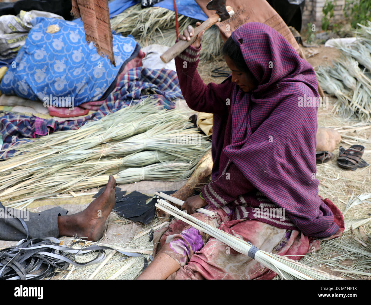 Jammu, India. 30th Jan, 2018. A non local workers busy in making brooms ...