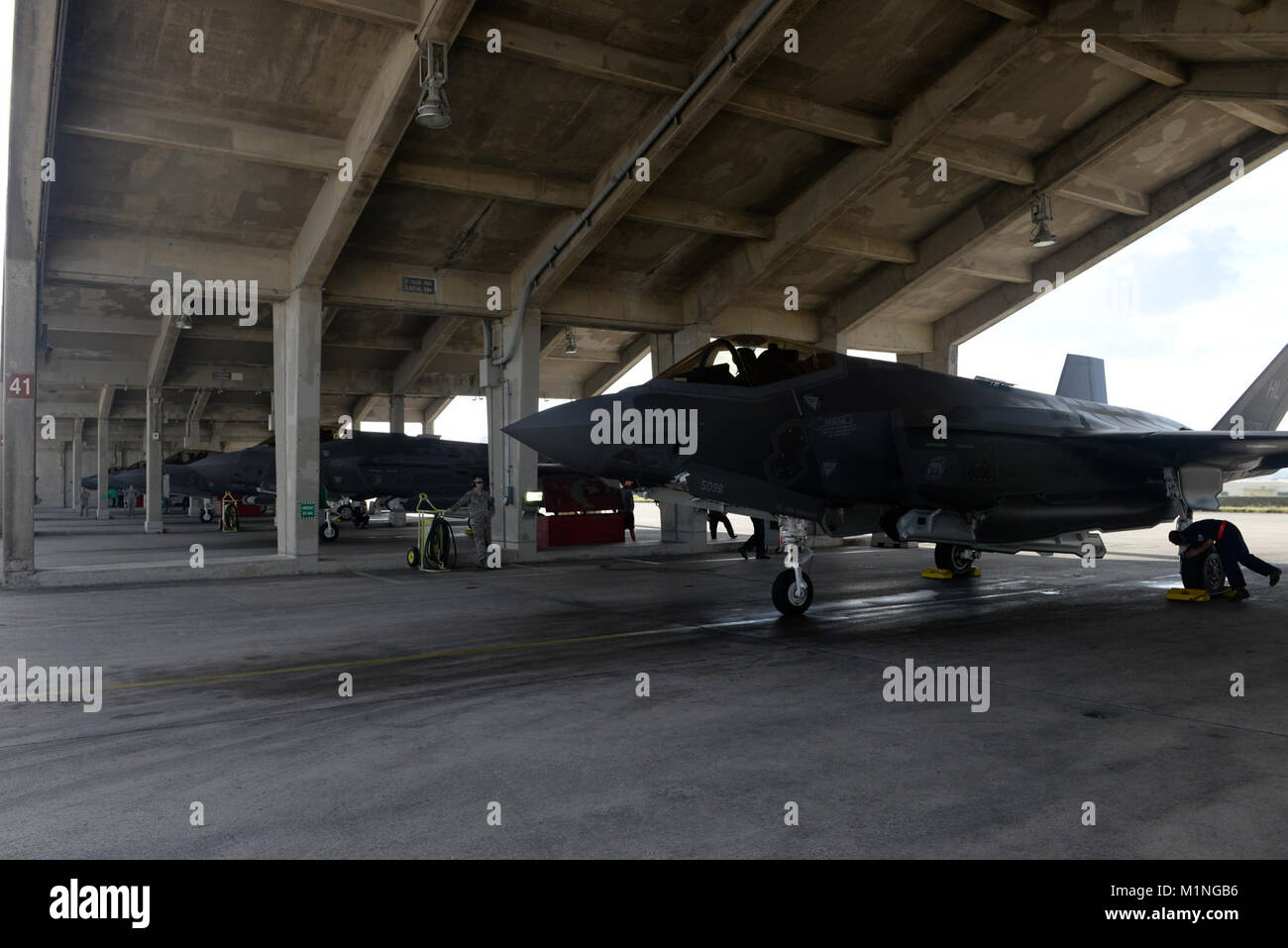 U.S. Air Force F-35A Lightning IIs sit beneath their temporary bunker ...