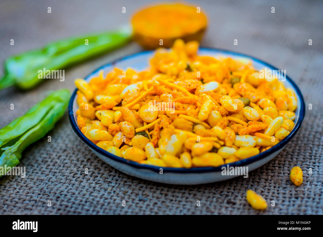 Close up Indian snack mix chevdo in a plate with green chillies Stock ...
