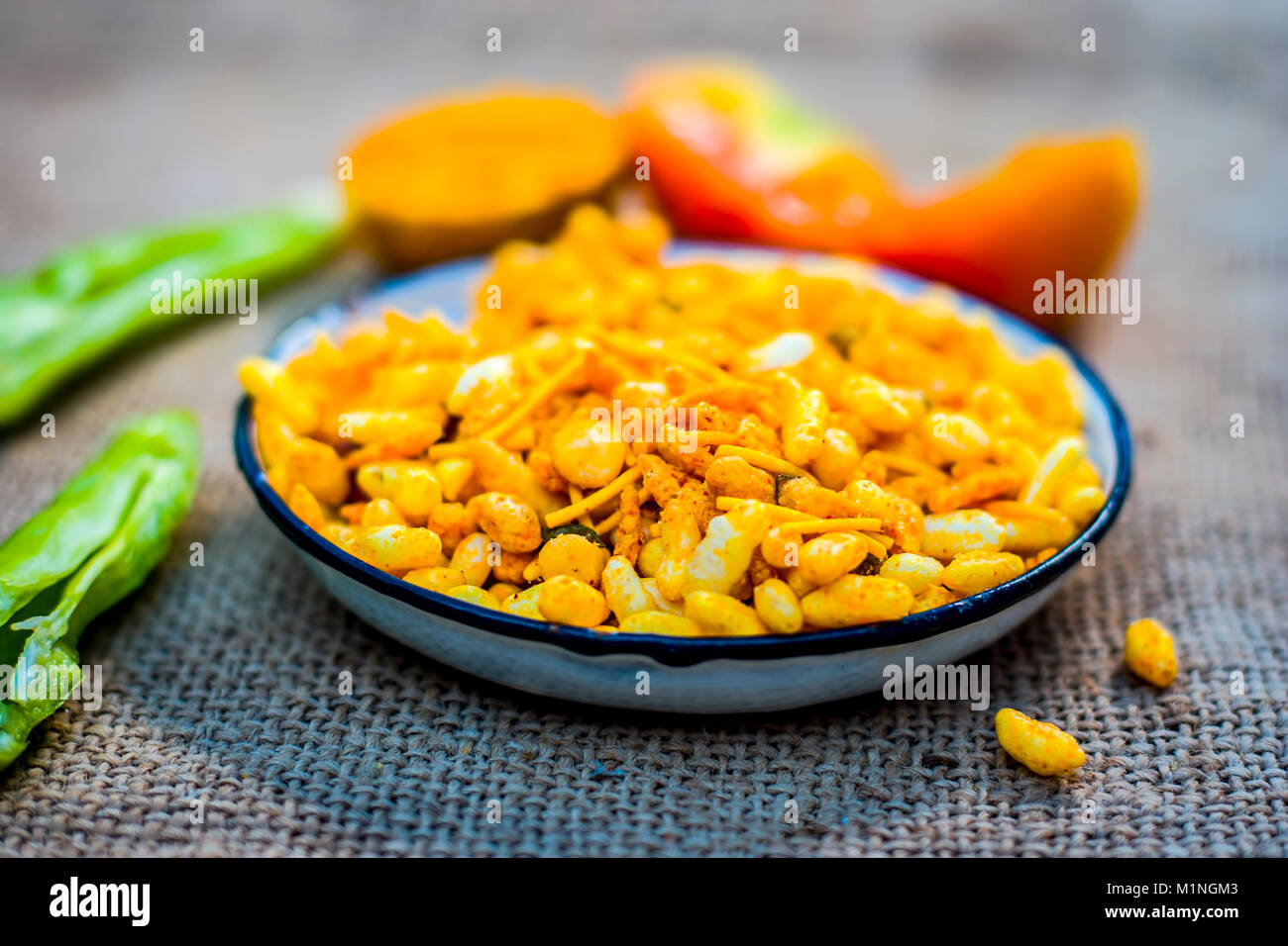 Close up Indian snack mix chevdo in a plate with green chillies Stock ...