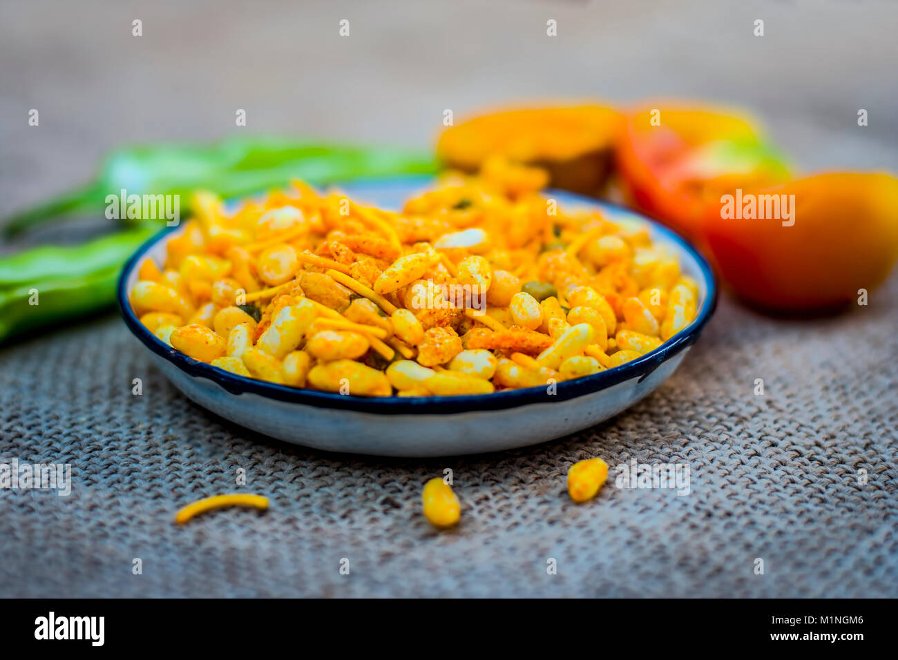 Close up Indian snack mix chevdo in a plate with green chillies Stock ...
