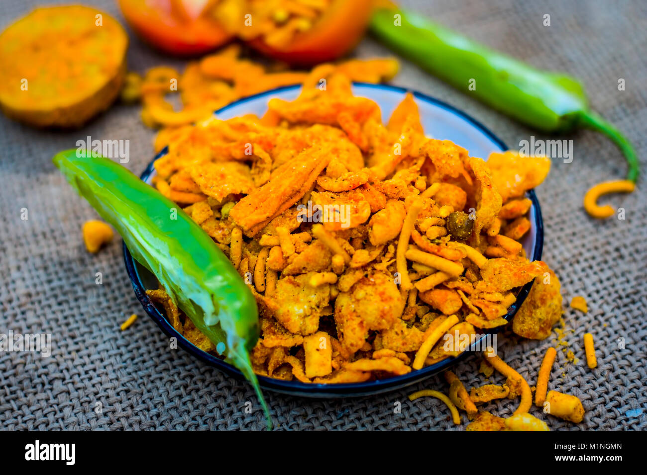 Close up Indian snack mix chevdo in a plate with green chillies Stock ...