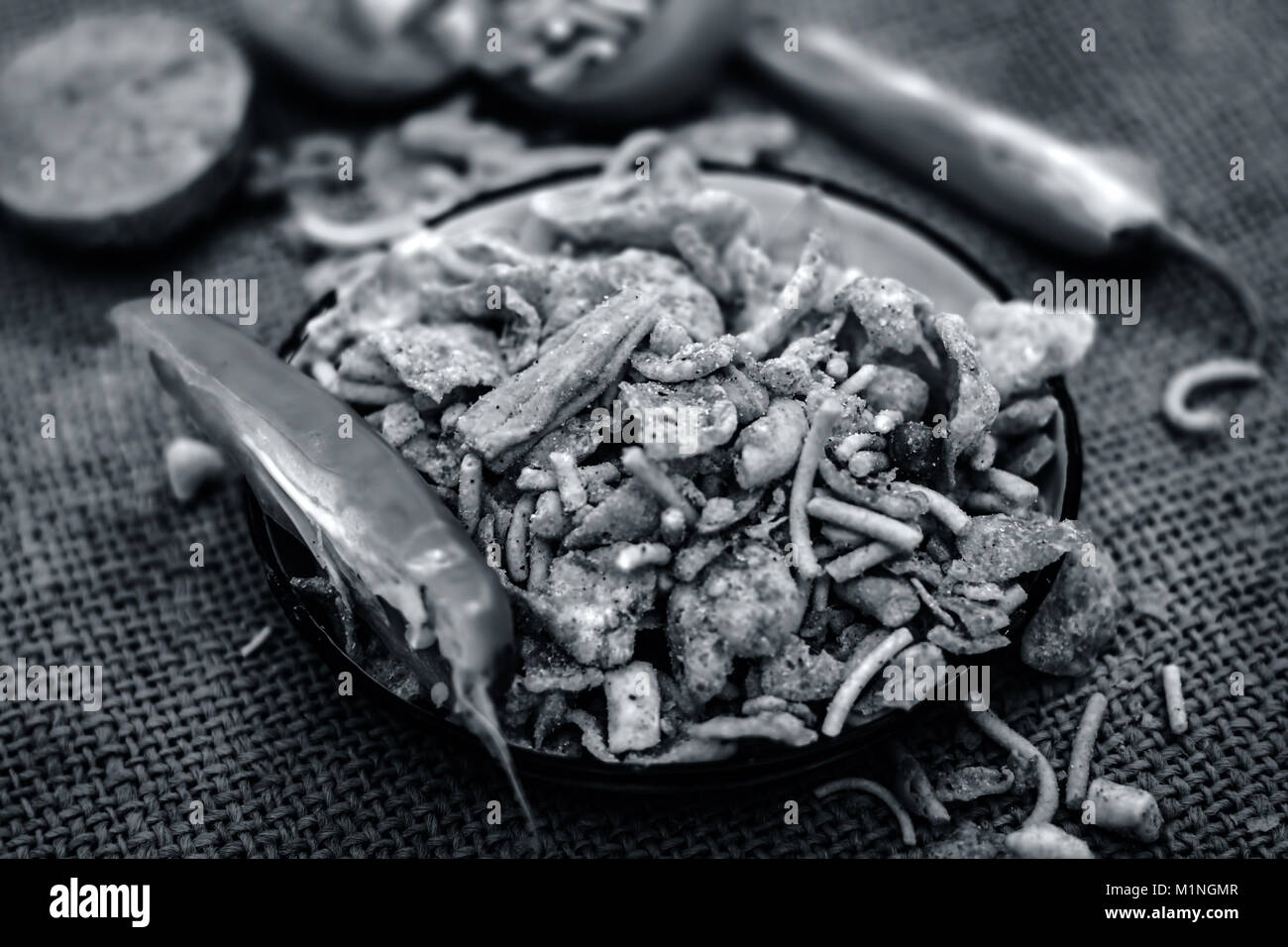 Close up Indian snack mix chevdo in a plate with green chillies Stock ...