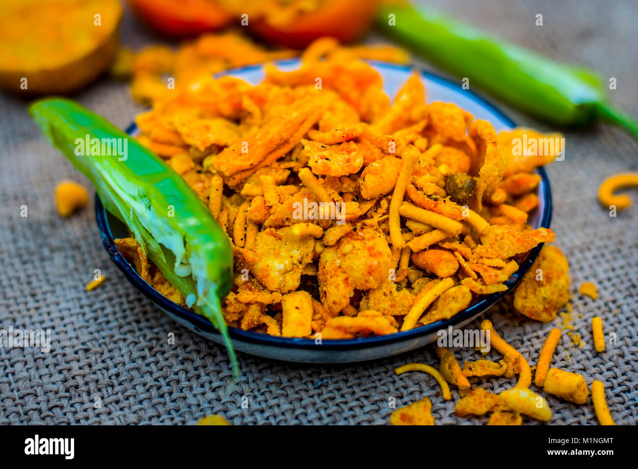 Close up Indian snack mix chevdo in a plate with green chillies Stock ...