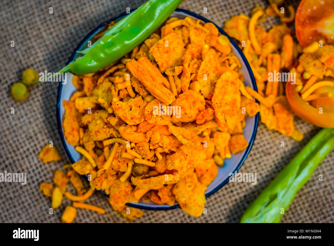 Close up Indian snack mix chevdo in a plate with green chillies Stock ...