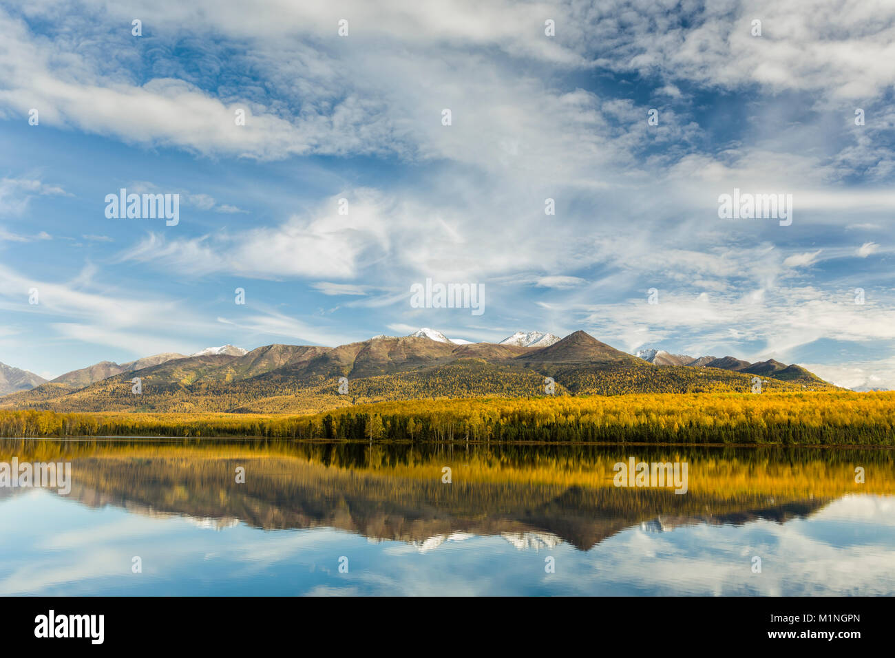 The Chugach Mountains of Eagle River are reflected in Clunie Lake on ...