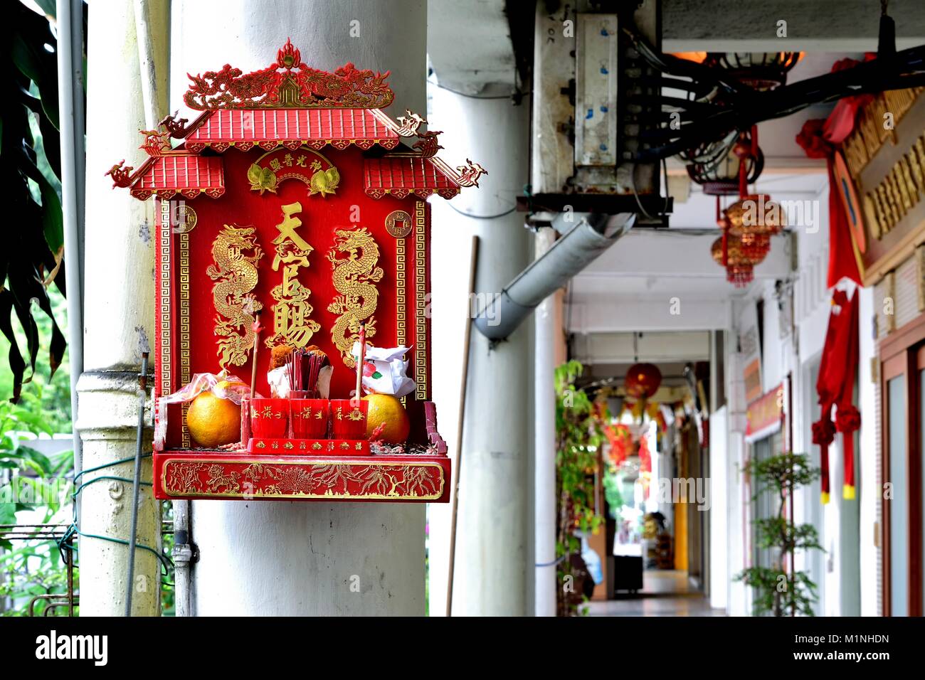 Buddhist street shrine with incense and offerings to the departed Stock Photo - Alamy