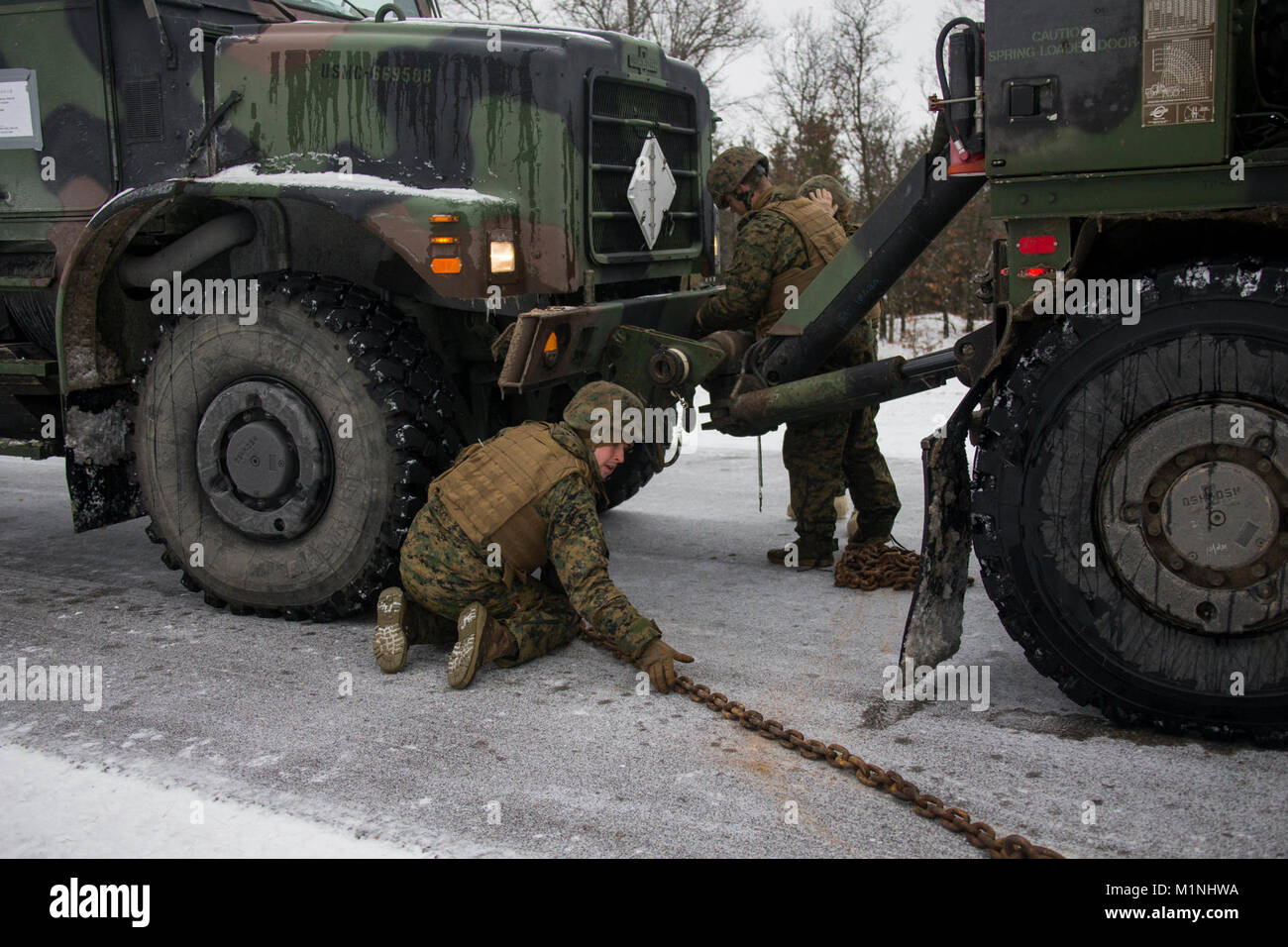 U.S. Marines with Marine Air Control Group 28 install a tow mount ...