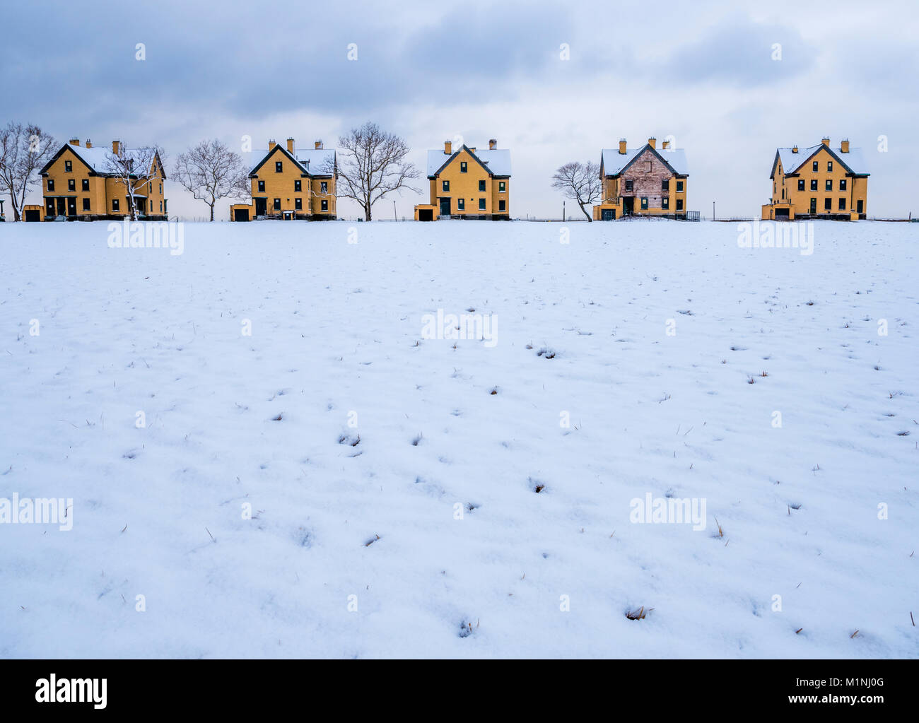 Winter rural scenery with the snow on the foreground and old abandoned ...
