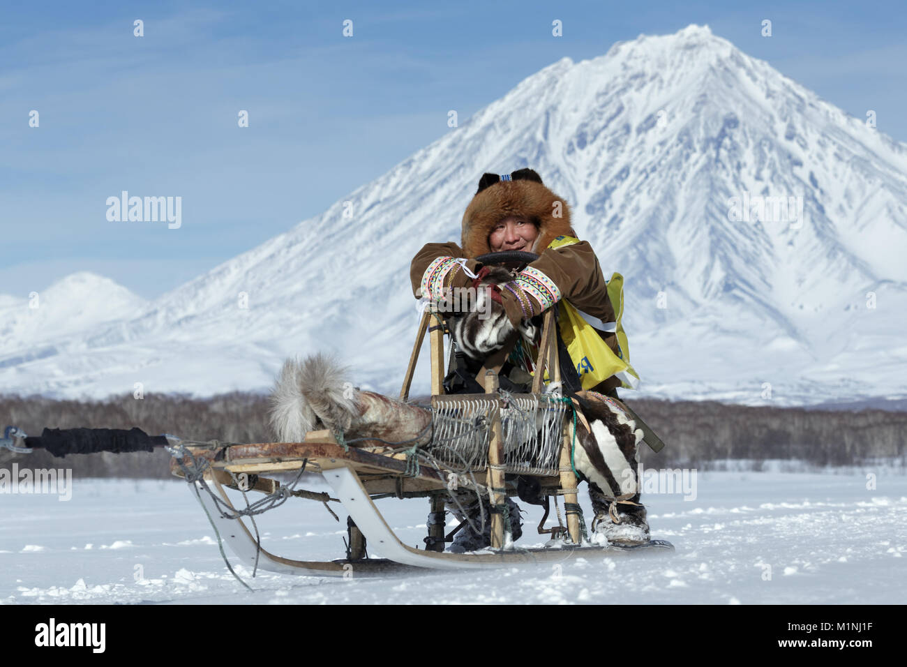 Kamchatka musher Mandyatov Roman dressed in national clothes rides on ...
