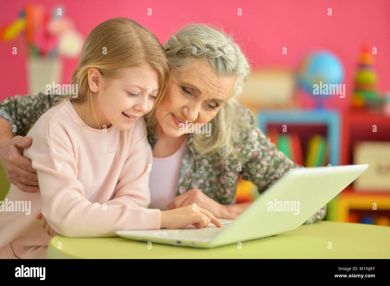girl with grandmother using laptop Stock Photo - Alamy