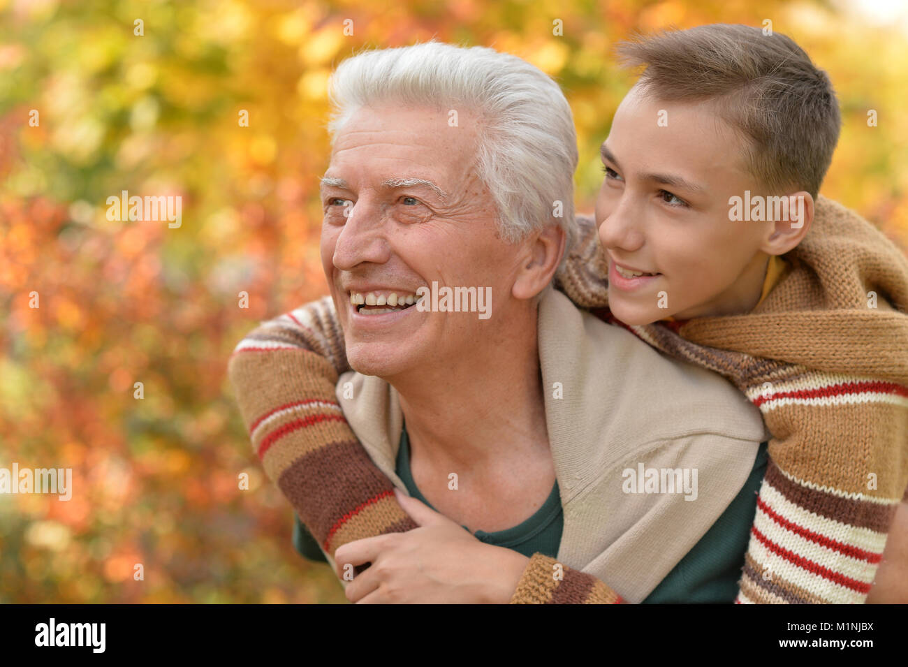 grandfather and grandson hugging in park Stock Photo - Alamy
