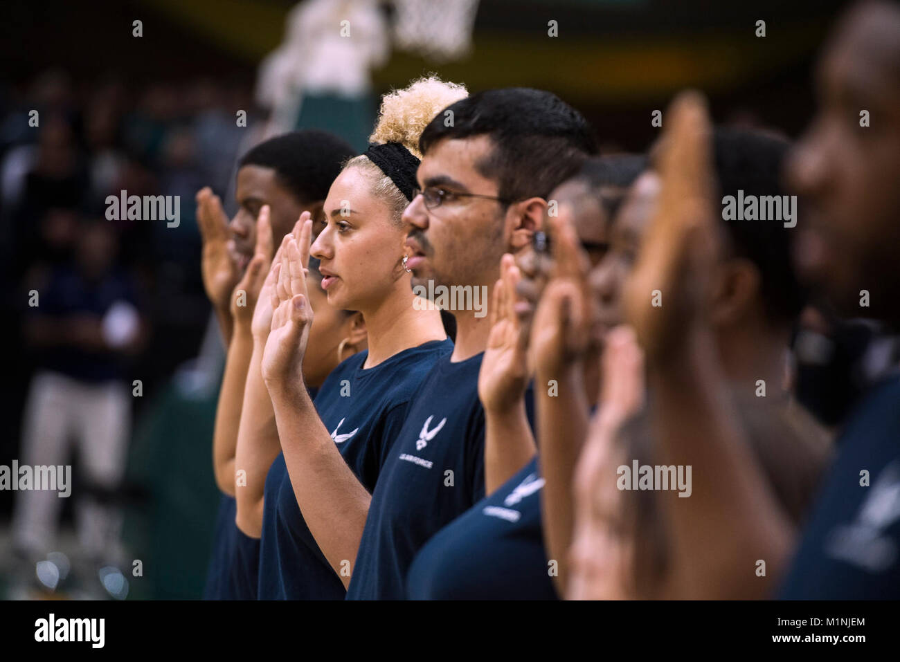 New Airmen take the oath of enlistment Jan. 26, 2016, during halftime ...