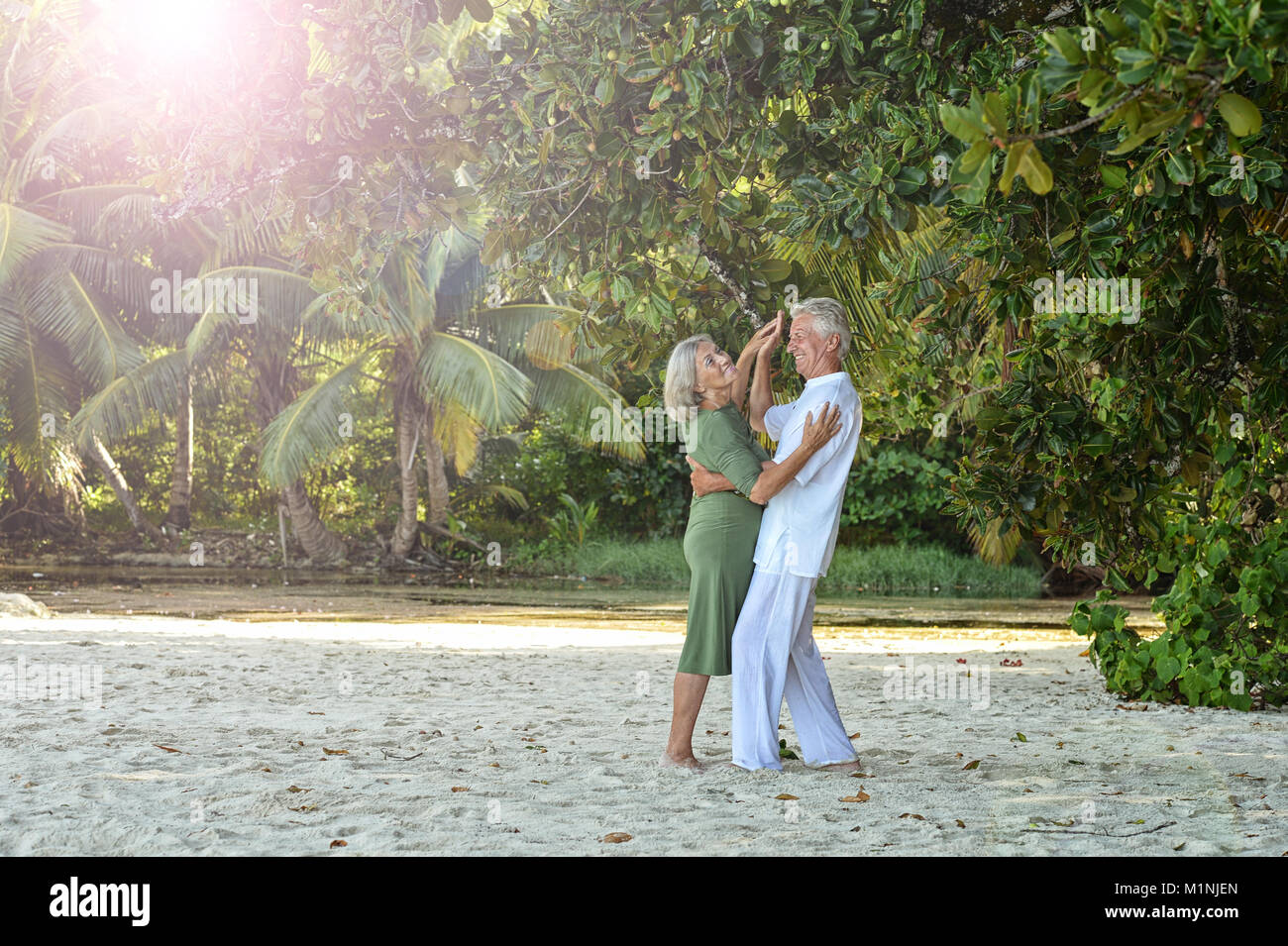 elderly couple rest at tropical resort Stock Photo - Alamy