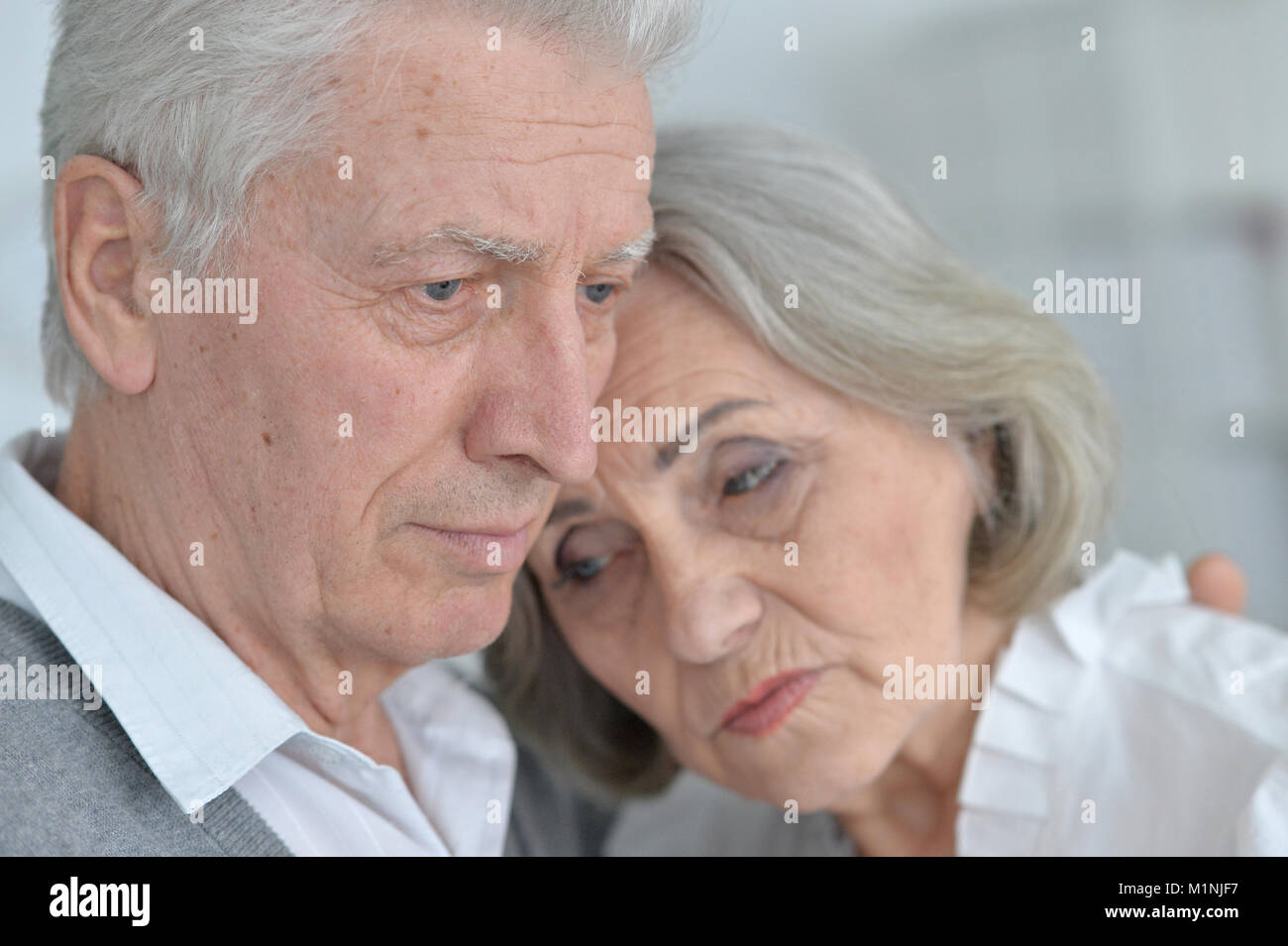 sad senior couple posing Stock Photo - Alamy