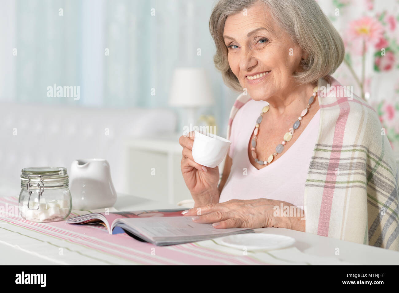 happy aged woman reading magazine Stock Photo - Alamy