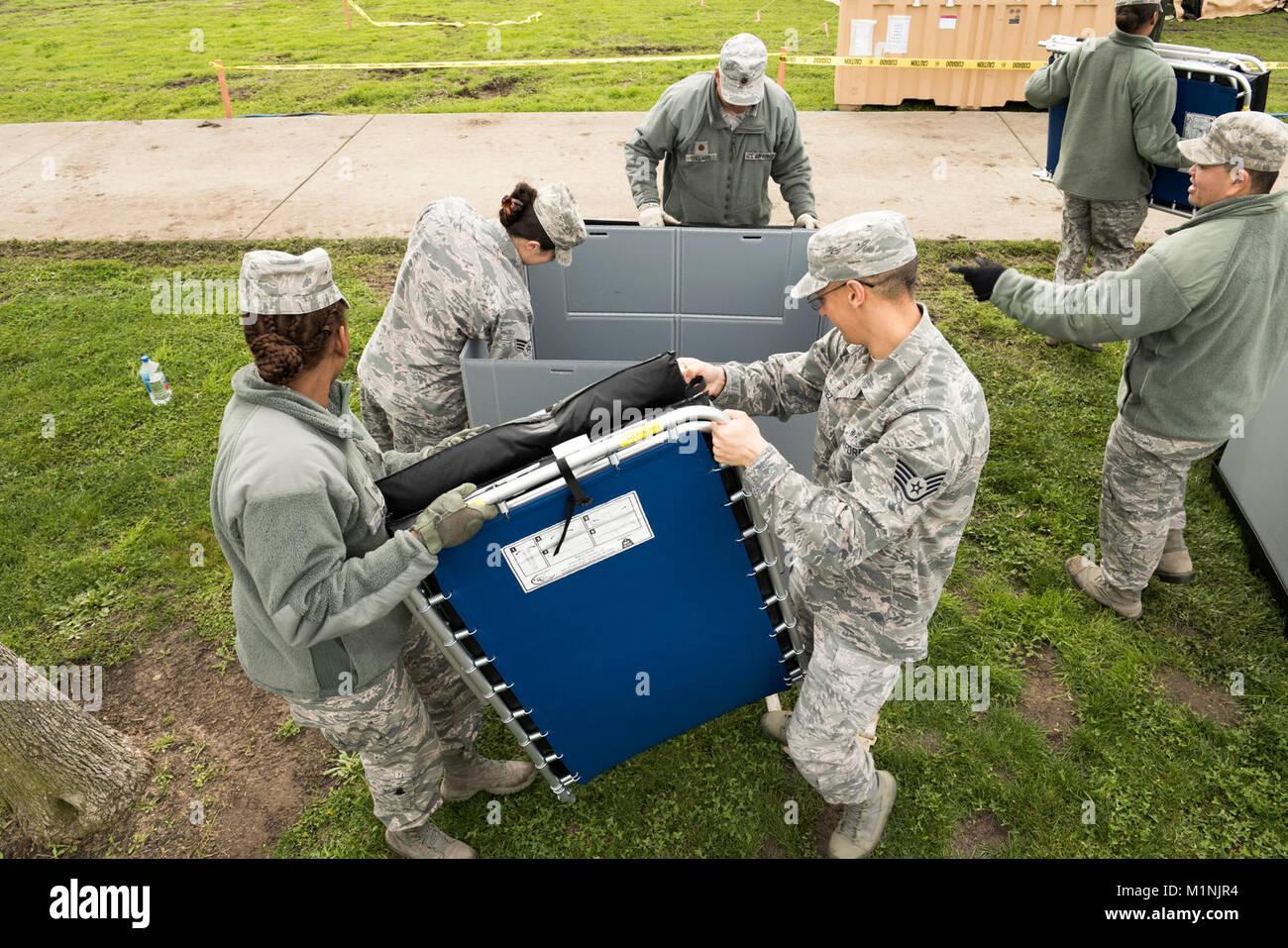 Airmen assigned to the 60th Medical Group unload equipment for an En ...