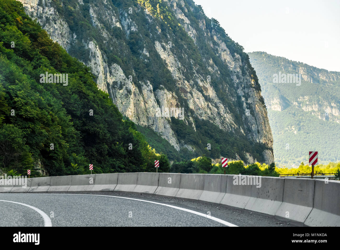 A sharp turn of a mountain road with a gray asphalt pavement Stock ...