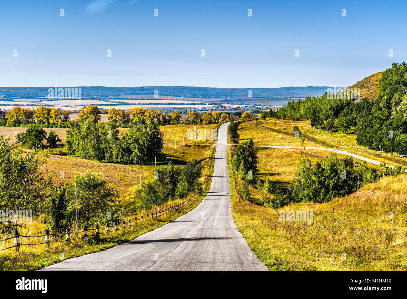 The asphalt road goes to the descent Stock Photo - Alamy