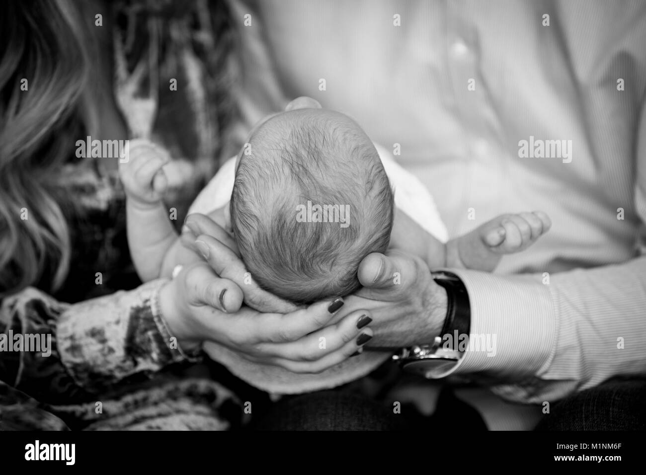 Parents holding newborn baby. Parenthood Stock Photo - Alamy