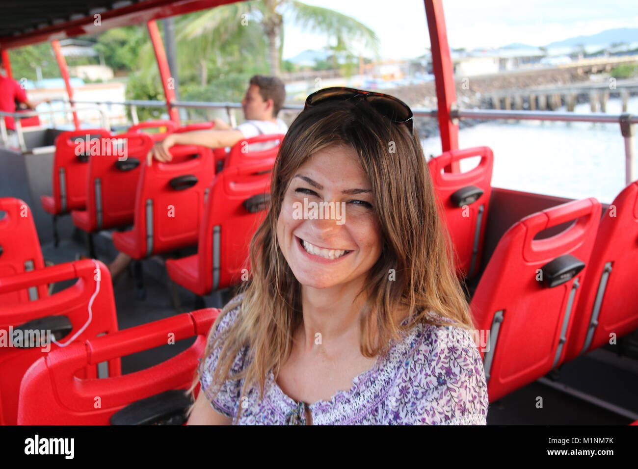Pretty young woman sitting on a tour bus visiting Panama City. Panama ...