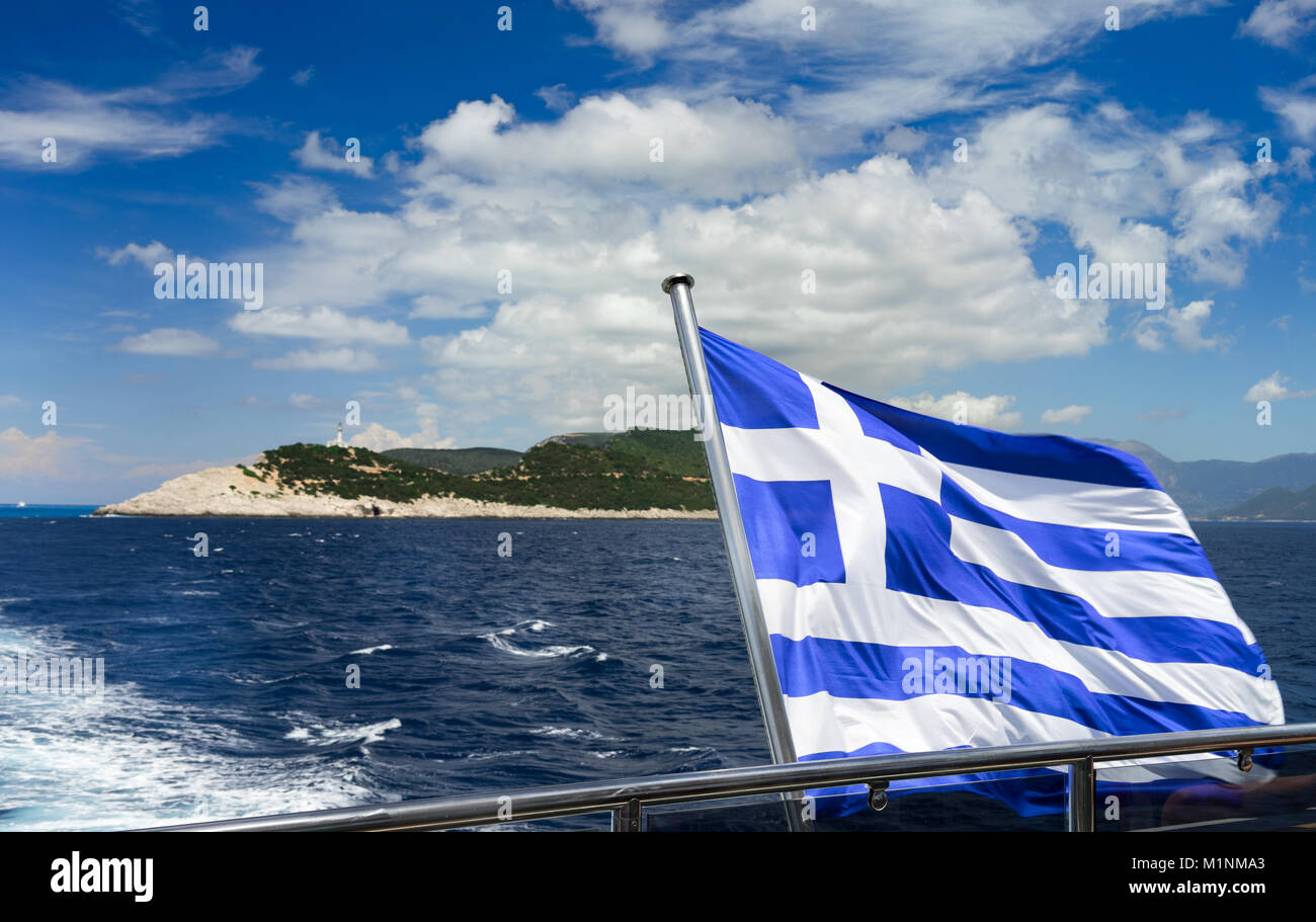 Greek flag on a cruise ship, light house on top of the rock on ...