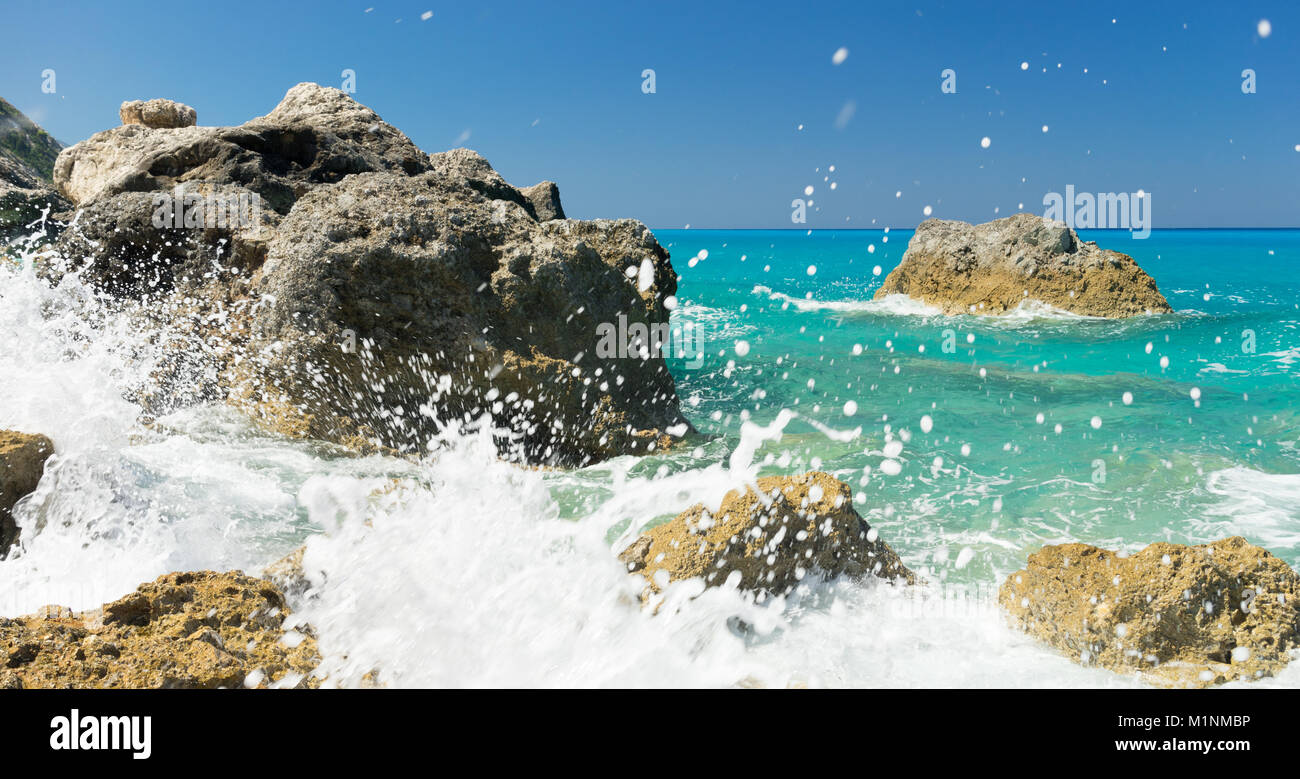 Sea wave covered the rock. Splashes and drops of water Stock Photo - Alamy
