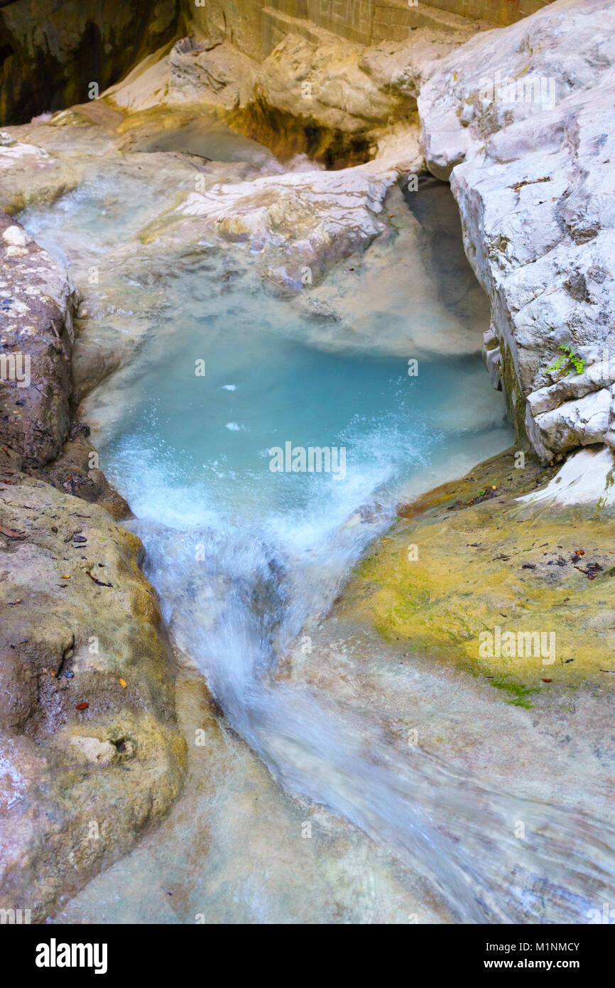 Waterfall surrounded by stones, clear turquoise water on an impressive ...