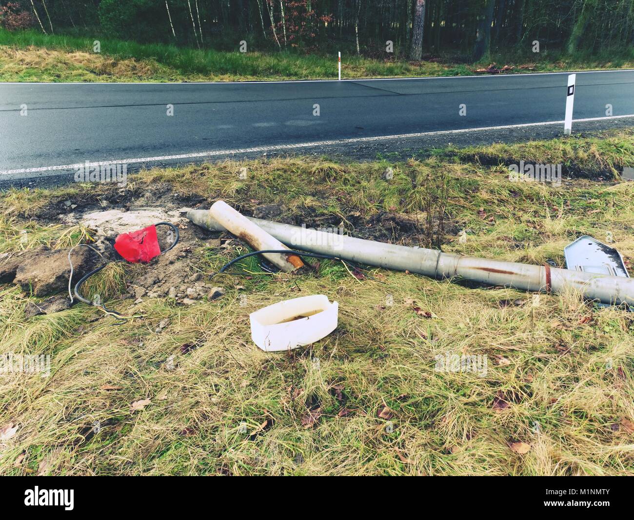 Broken lamp post after car accident. Freeze morning with slippery ...