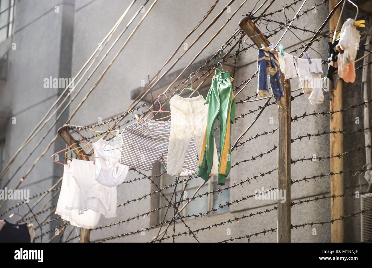 Laundry dries on a barbed wire fence in Macao Special Administrative Region. (07 January 2016 ...