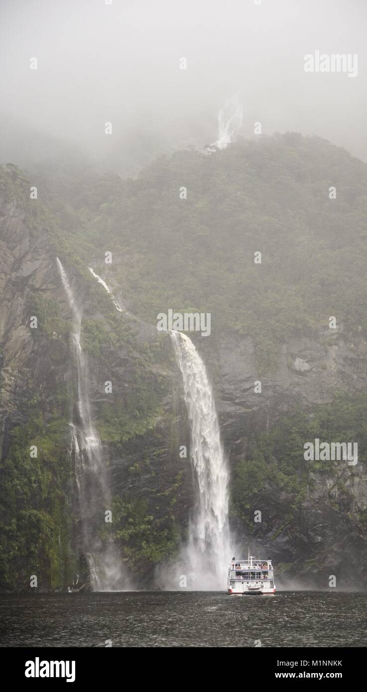 A ship with tourists is approaching one of the huge waterfalls on the ...