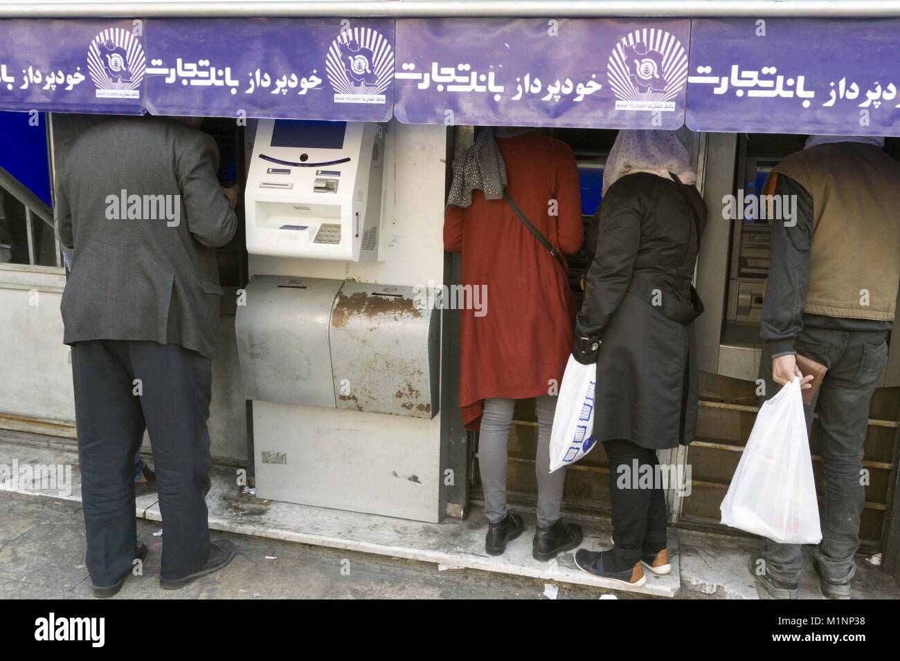 Iranians withdraw money from an ATM machine in Tehran, Iran, 20 ...
