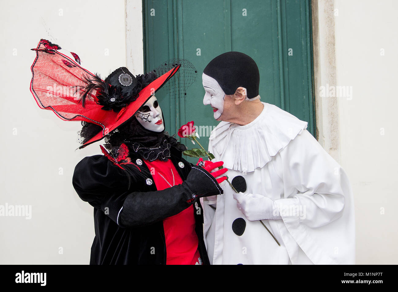 Couple of Venetian Masks - Pierrot and woman in red with Rose on San ...