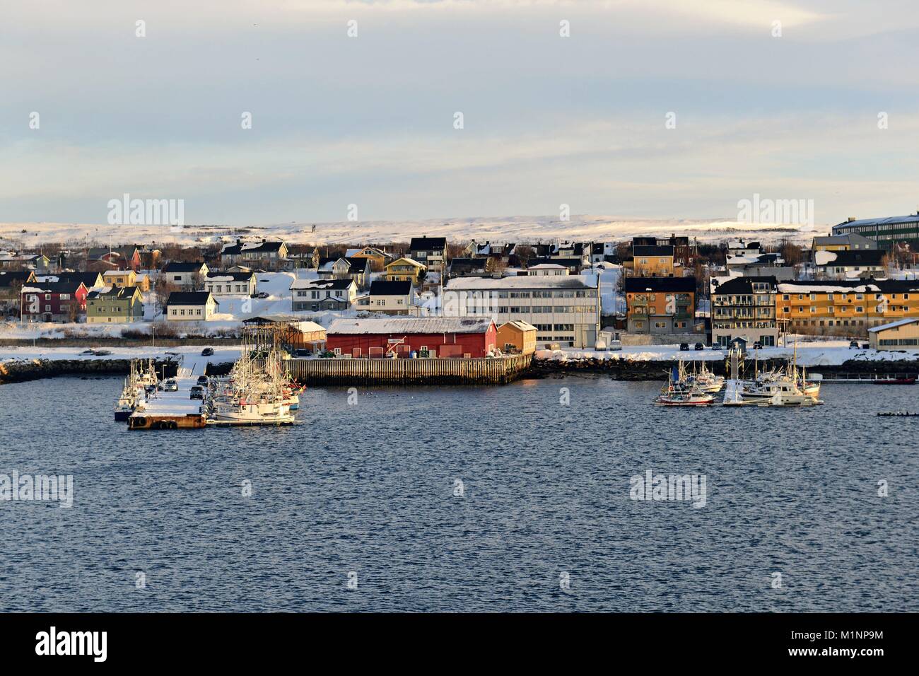 Boat bridges with boats in the harbour basin from the town Vadsø with ...