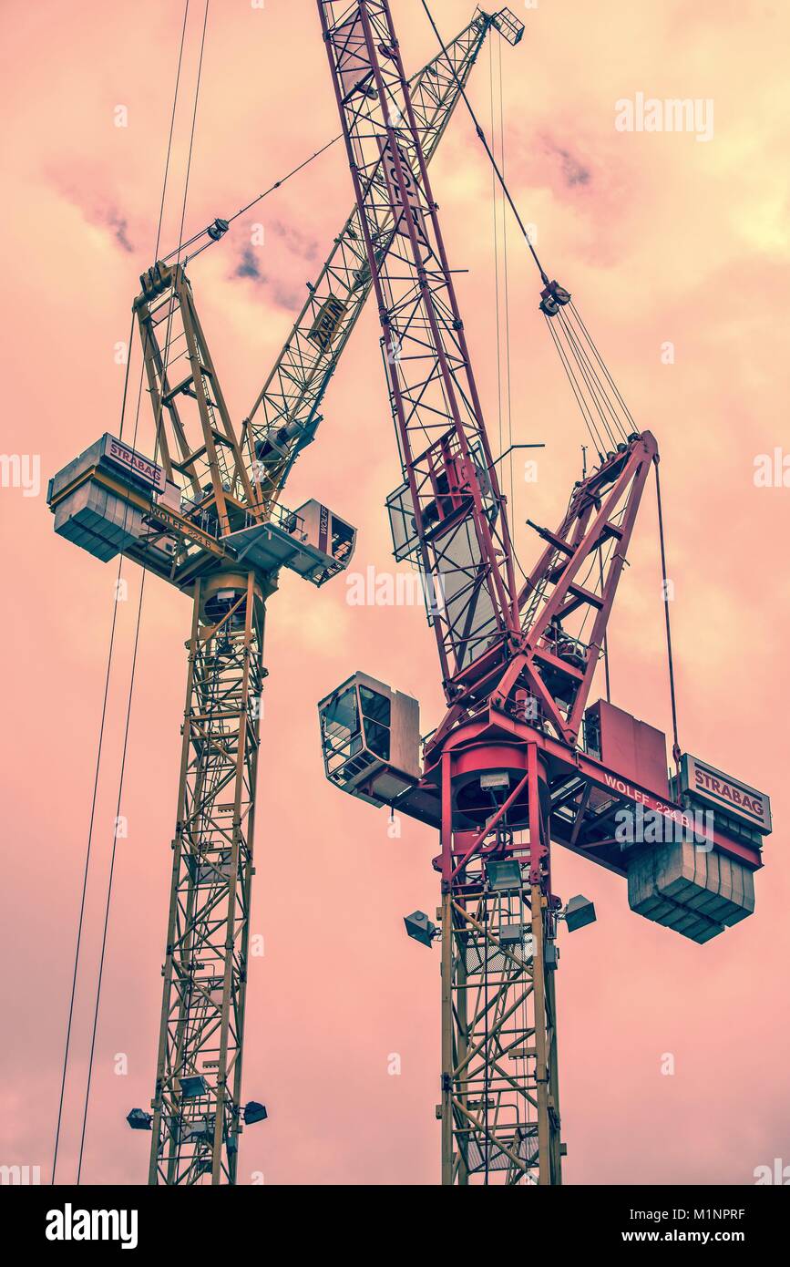 Two building cranes from Strabag in front of red sky | usage worldwide ...