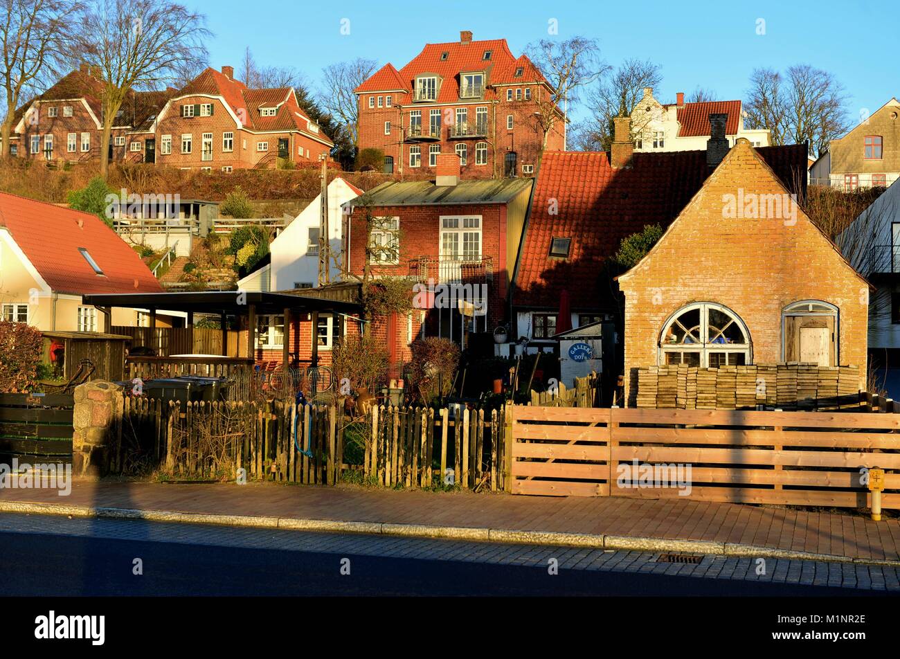 Several houses in the evening light at the harbor in Sonderburg ...