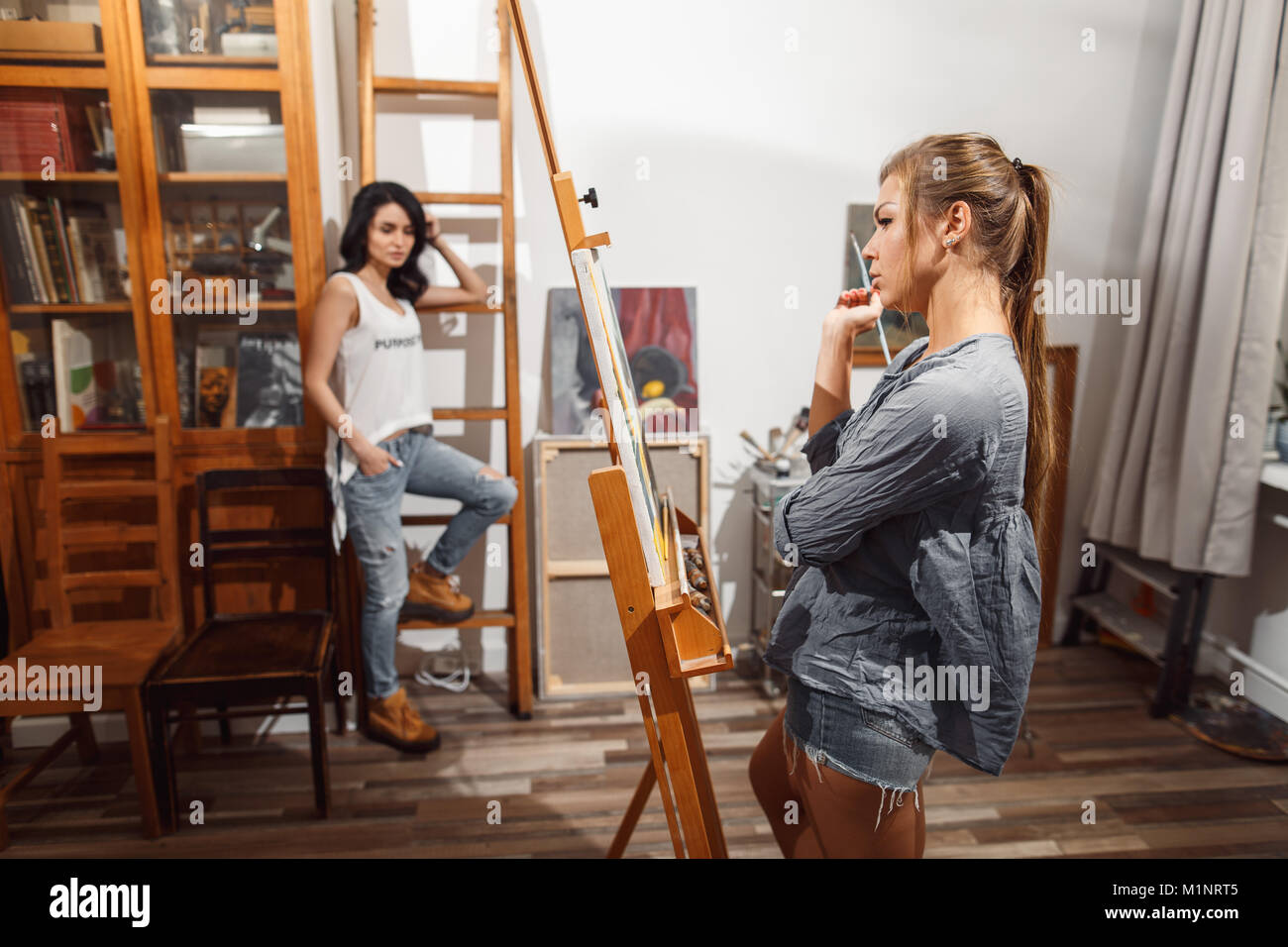two girls in an artist studio. paints model Stock Photo - Alamy